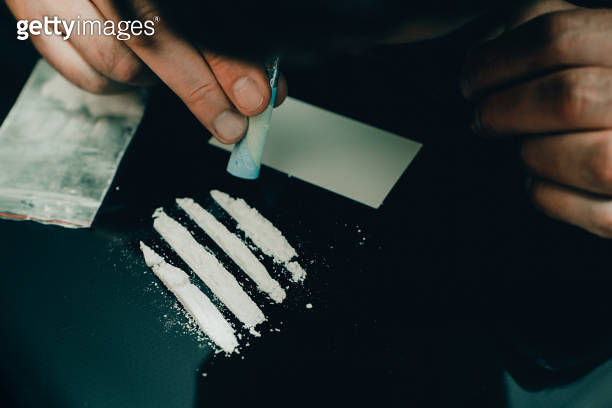 Drug addict. Drug abuse, man taking drugs, snorting lines of cocaine ...