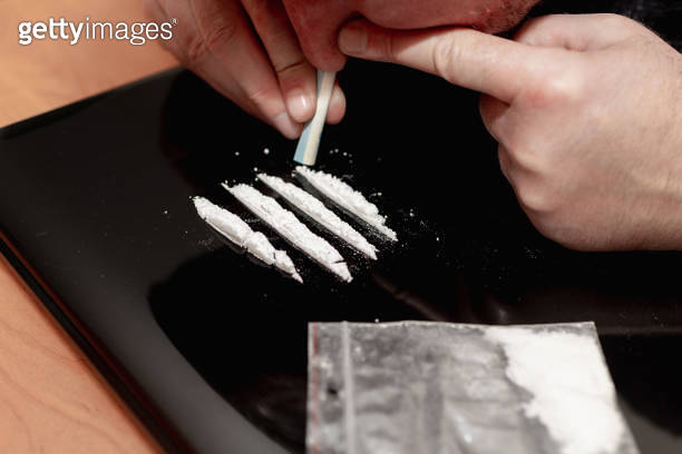 Drug addict. Drug abuse, man taking drugs, snorting lines of cocaine ...