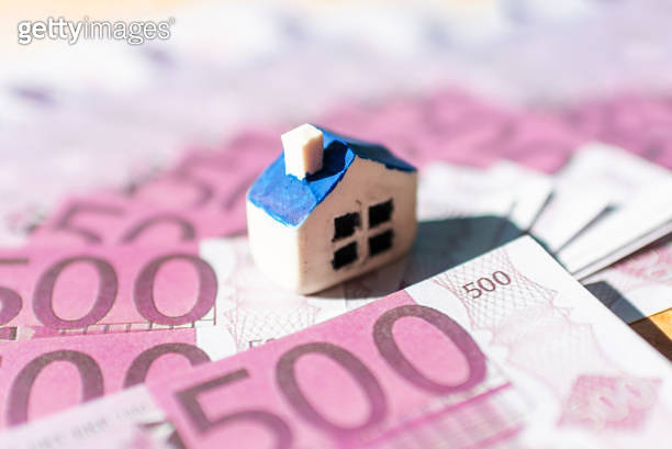 Miniature toy house placed on Euro bill banknotes. Concept for real ...