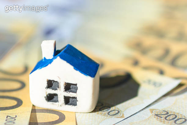 Miniature toy house placed on Euro bill banknotes. Concept for real ...