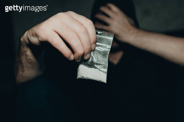 Criminal holding plastic bag with drug.Man holding transparent plastic ...