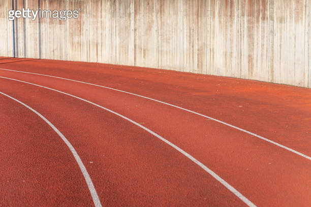 Part Red plastic track in the outdoor track and field stadium.Close-up ...