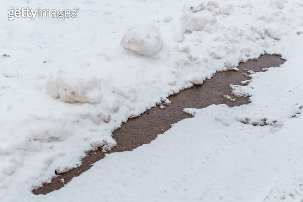 part of street in city, pavement wet snow melts, concept traffic safety ...