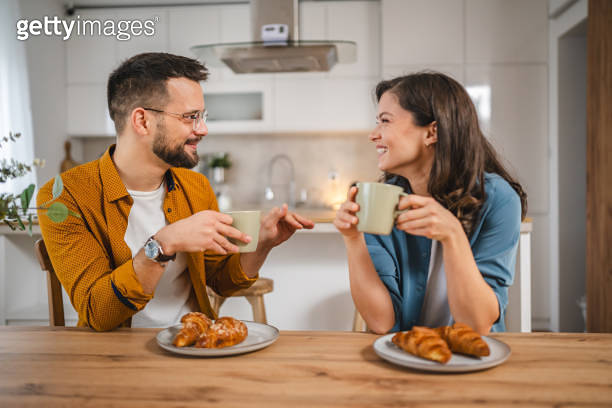 Adult couple have breakfast and cup of coffee at home morning routine ...