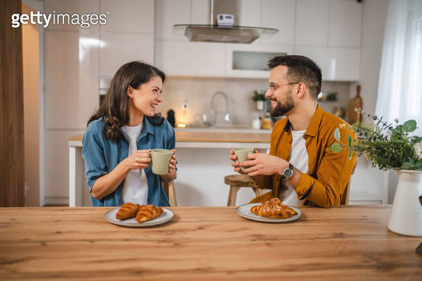 Adult couple have breakfast and cup of coffee at home morning routine ...