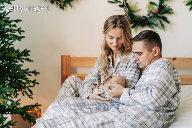 Caring loving parents care for a newborn baby. Mom and dad are holding ...