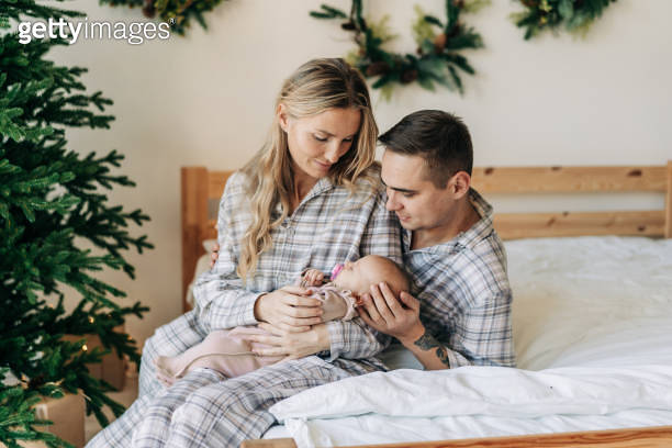 Portrait of caring loving parents caring for a newborn baby. Mom and ...