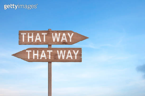 Crossroad signpost saying this way, that way, the other way concept for ...