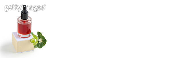 Serum dropper bottle on the podium at white background. Natural ...