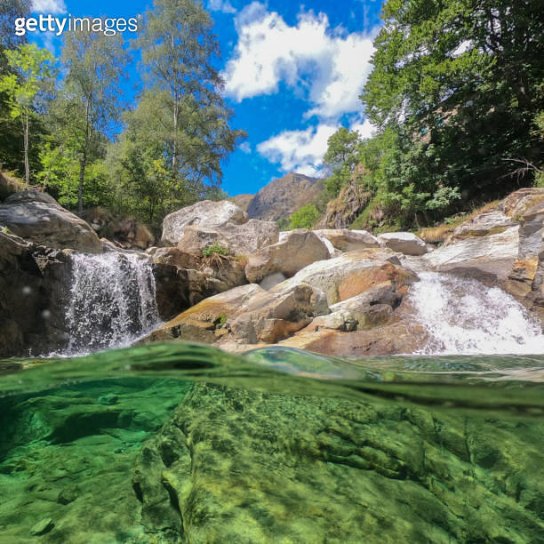 Beautiful view of little pond and waterfall. Mountain scenery with ...