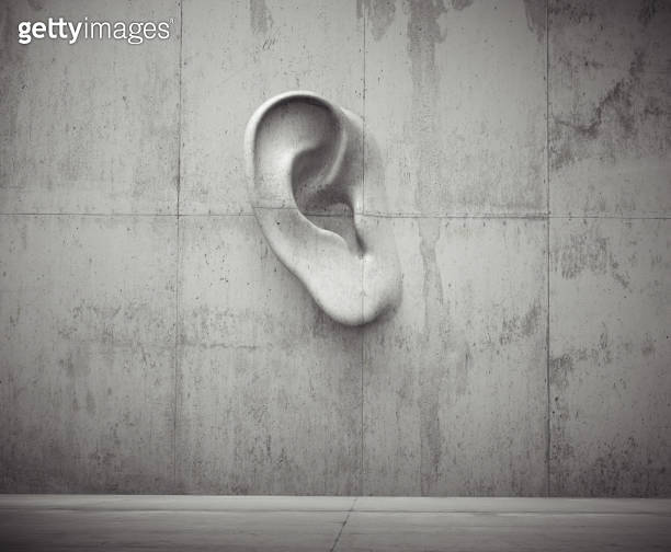 Cement sculpture in the shape of a human ear on a concrete wall ...