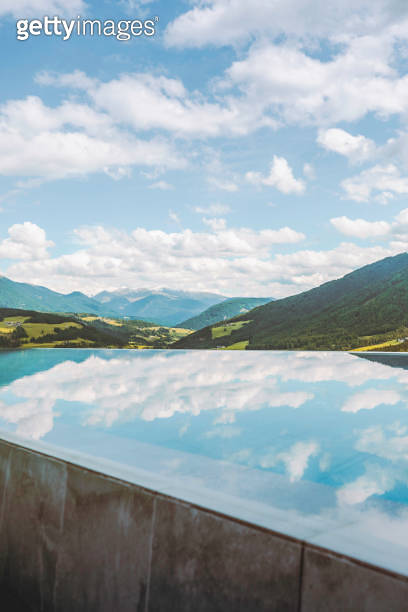 View of an infinity pool at a luxury resort hotel on a sunny day in ...