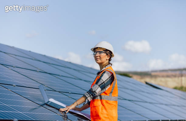 Solar Power Sentinel: Portrait of a Young Female Electrical Engineer ...