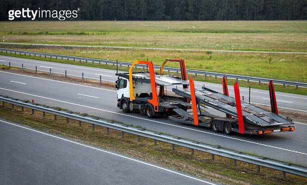 An empty tractor-trailer truck with a semi-trailer car transporter ...