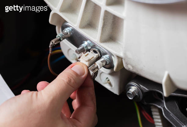 The hand of the master disconnects the electrical chip from the ...