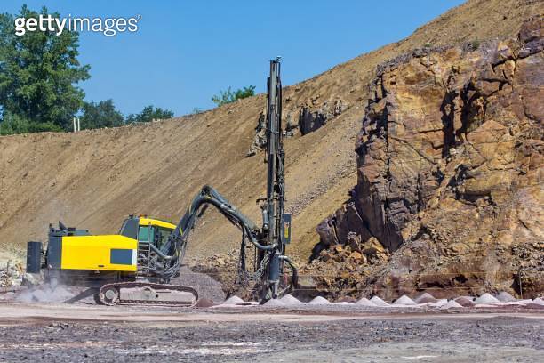 The Vertical drilling rig machine in stone quarry. Drilling Tractor Working in the Mine. Mining ...