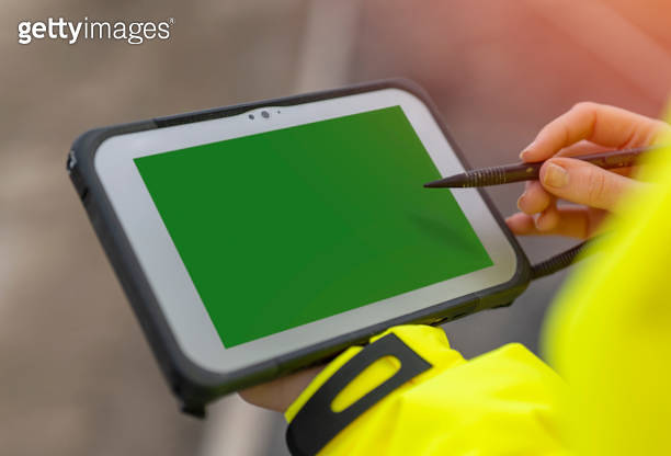 hands of female site engineer surveyor working with rugged controller ...