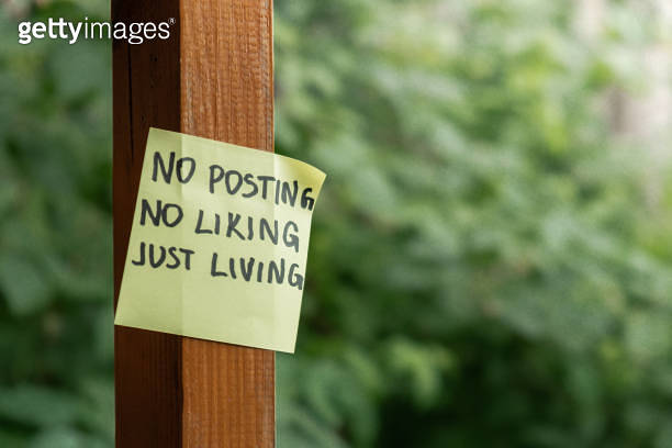 NO POSTING NO LIKING JUST LIVING text on paper note on background of ...