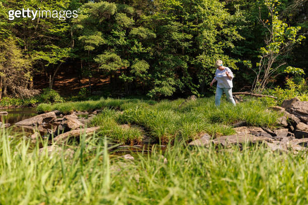Mature woman travelling in nature in Poconos, PA. Female tourist ...