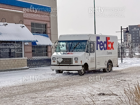 A Fedex truck parked in a Walmart store during a snow fall in winter ...