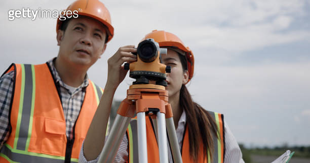 Senior construction male engineer training a young new female engineer ...