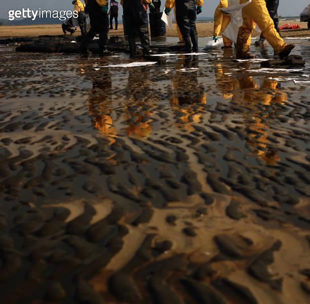 A crude oil spill on the sand of a city beach Beach oil spill impacts ...