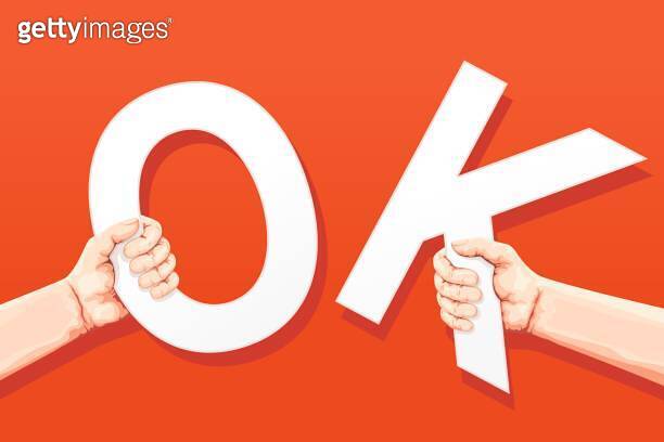 OK. Two hands on different sides hold the letters O and K. Concept of ...