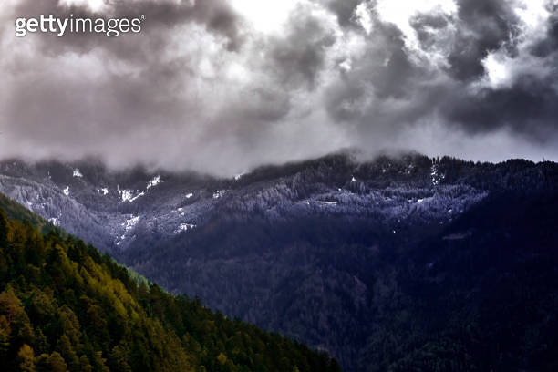 Alpine Peaks with Remnants of Snow and Visible Snow Line in Dark Clouds ...