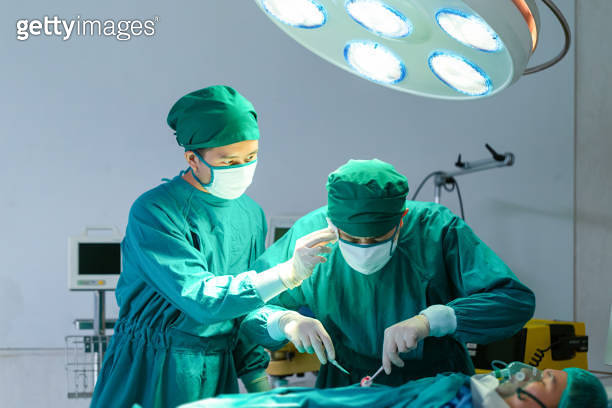 Medical team performing a surgical operation in operating Room ...