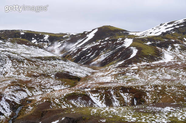 Reykjadalur Valley in autumn snow and hot springs, boiling mud pits ...