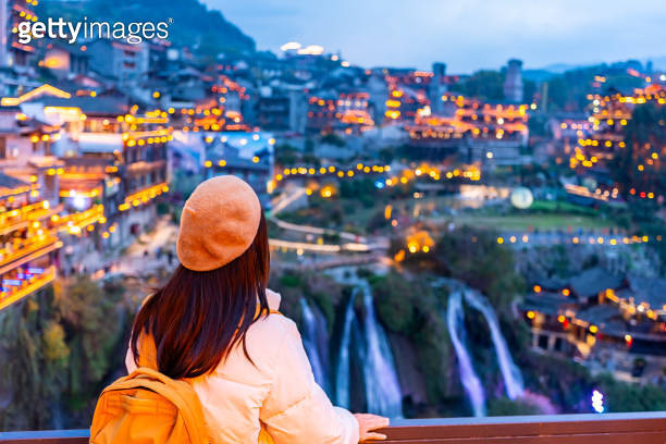 Young female tourist enjoying beautiful landscape at the Furong old ...