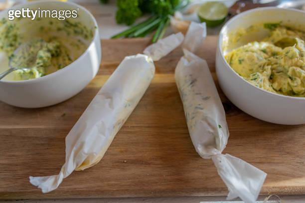 Fresh and homemade herb butter wrapped in paper (2149152706) - 게티이미지뱅크