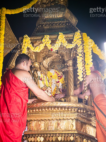 Temple priest during Krishna temple rath yatra where large chariots ...