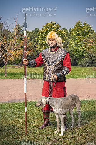 Young guy in the national costume of a Kazakh warrior stands with a ...