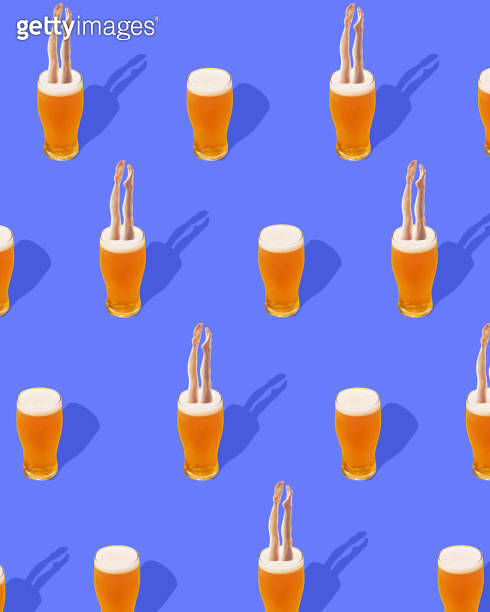 Girls in swimsuit diving into glass of lager frothy beer against blue ...