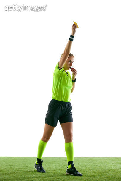 Serious woman, soccer referee gesturing, raising hand, stopping game ...