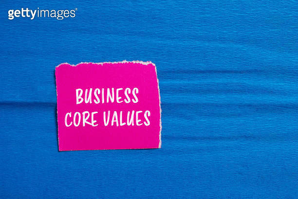 Business core values message written on ripped torn pink paper piece ...