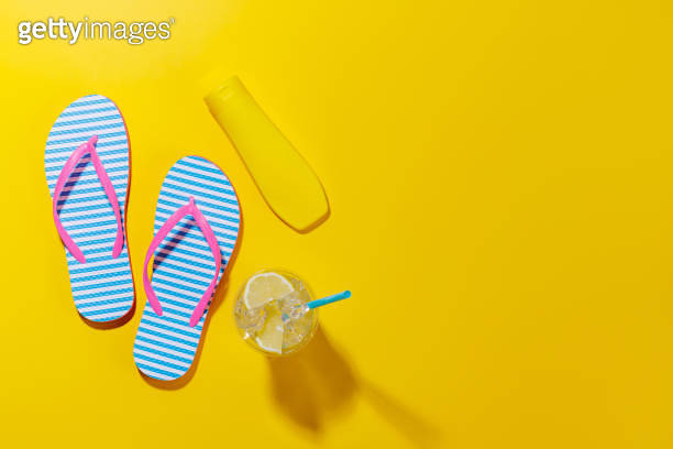 A vibrant summer vacation scene with flip flops and cocktail ...