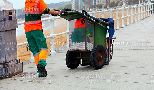 Female street sweeper with cart, broom and dustpan in San Lorenzo beach ...