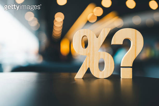 Percentage and question mark on wood table in blur urban background ...
