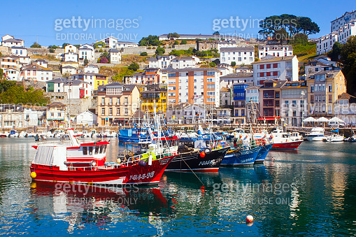 Luarca harbour. Multicolored fishing boats and townscape. Asturias ...