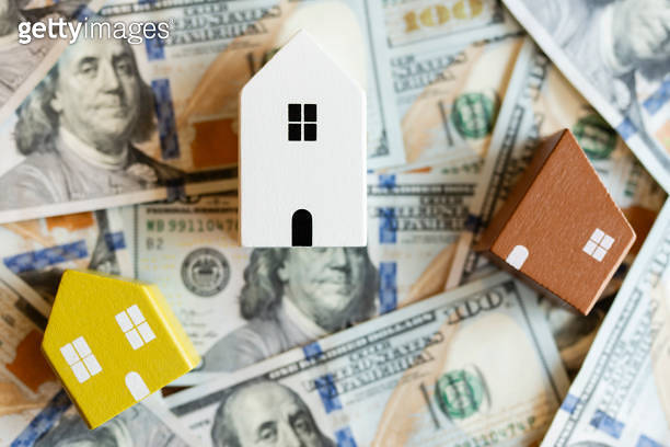 House symbol placed on dollar bill and concept of real estate ...