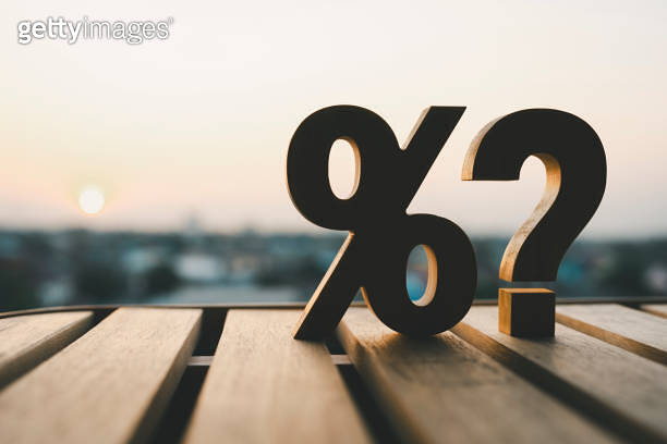 Percentage and question mark on wood table in blur urban background ...