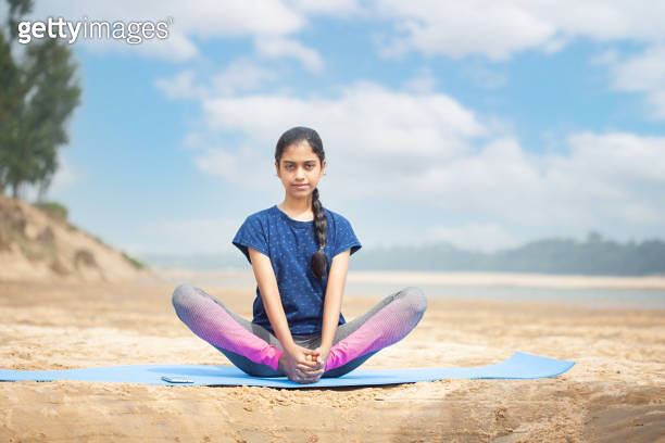 indian serene girl sitting in a cobbler pose doing Baddha Konasana ...