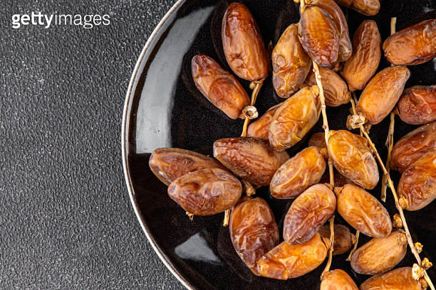 date on a branch dried sweet fruit fresh appetizer meal food snack on ...