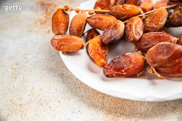 date on a branch dried sweet fruit fresh appetizer meal food snack on ...