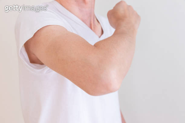 A man poses with his elbow bent and one arm raised 이미지 (2149475107 ...