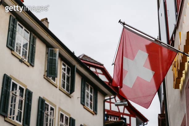 Swiss Flag Waving In The Wind On A Building In Switzerland 이미지 ...