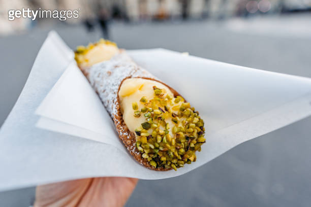 Young Man Holding A Cannoli Pastry Filled With Creamy Ricotta And ...