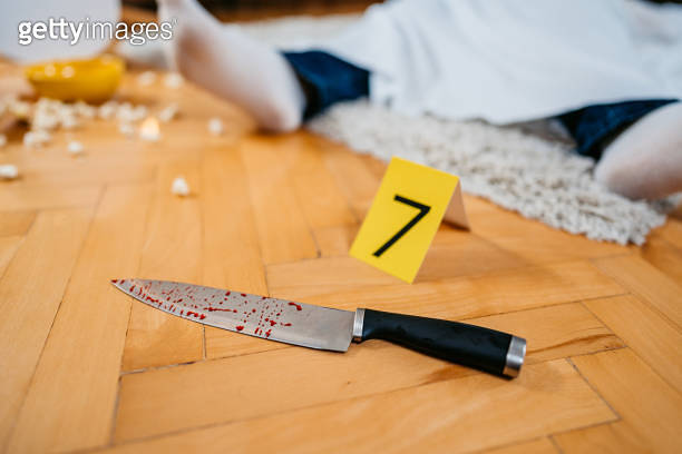 A Knife Marked As Evidence Next To A Murder Victim Lying On The Floor ...